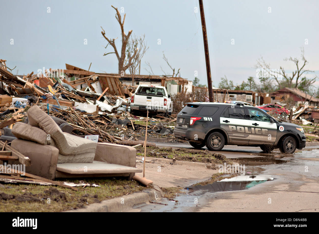 Resident sifts through the remains of homes in the aftermath of an EF-5 ...