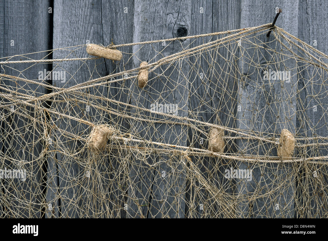 Fish net drying in front of a wooden shed Stock Photo - Alamy