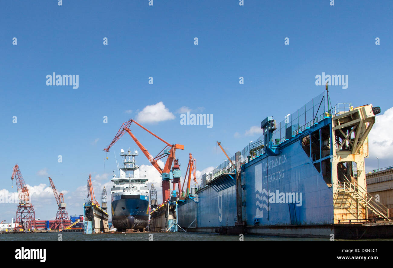 Industrial cranes at a shipyard and floating dry dock in Gothenburg ...