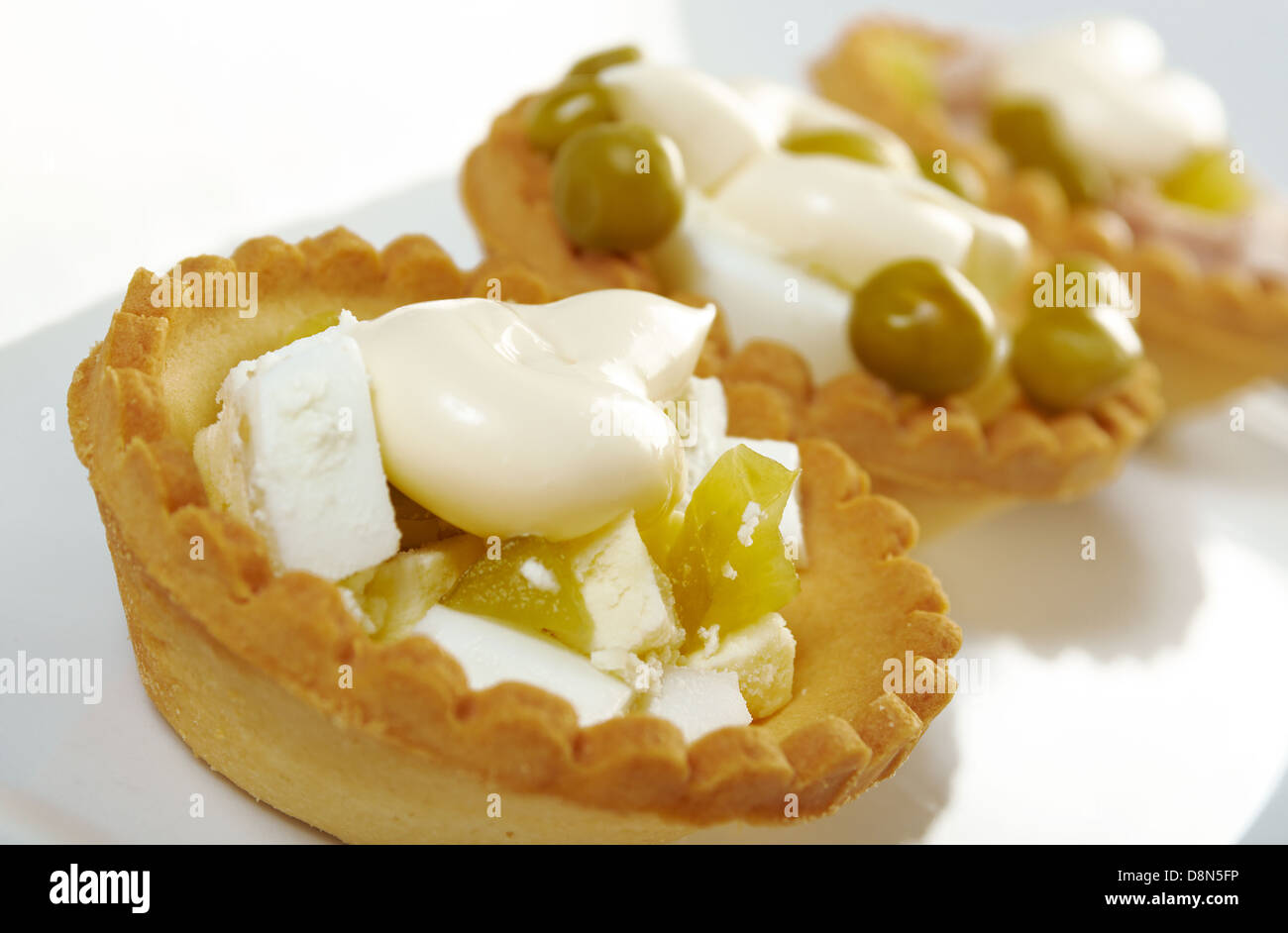 tartlet with salad on a white plate Stock Photo - Alamy