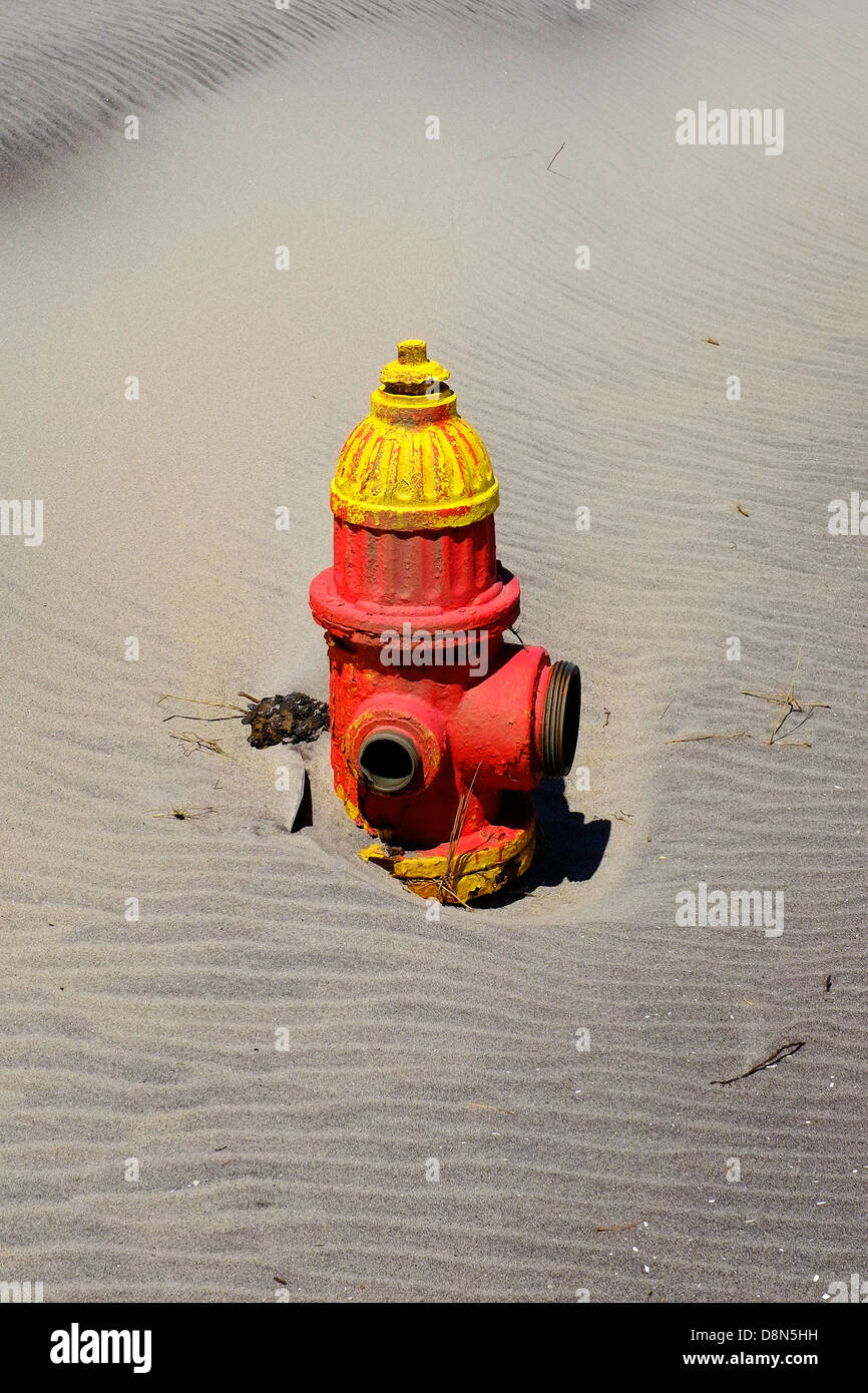 A traditional American fire hydrant buried in drifting sand on the ...