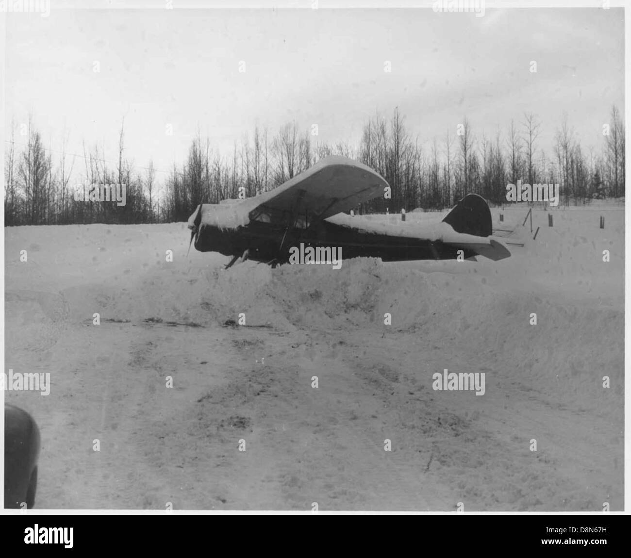 A vintage photograph of an aircraft surrounded by snow, showcasing the ...