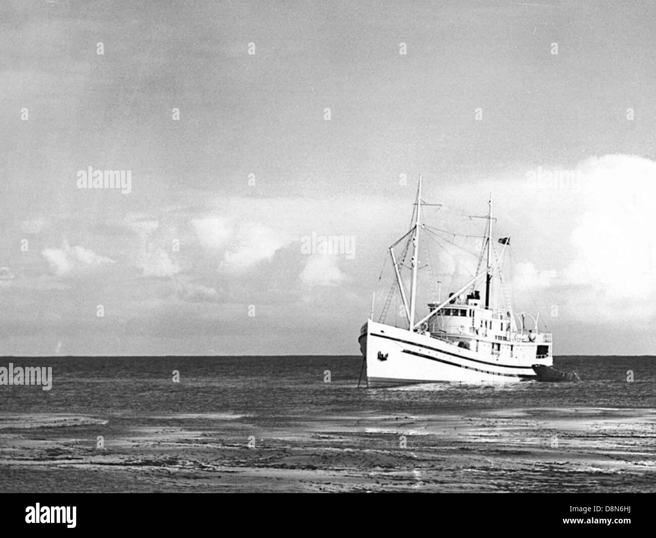 A native bidarka, a traditional Aleutian kayak, is shown alongside a ...