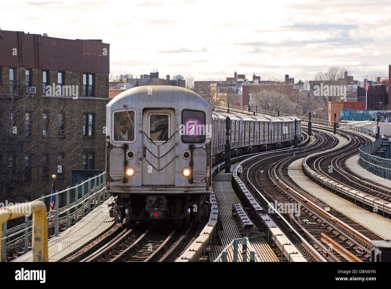 Number 7 train elevated subway approaching the Woodside Avenue station ...
