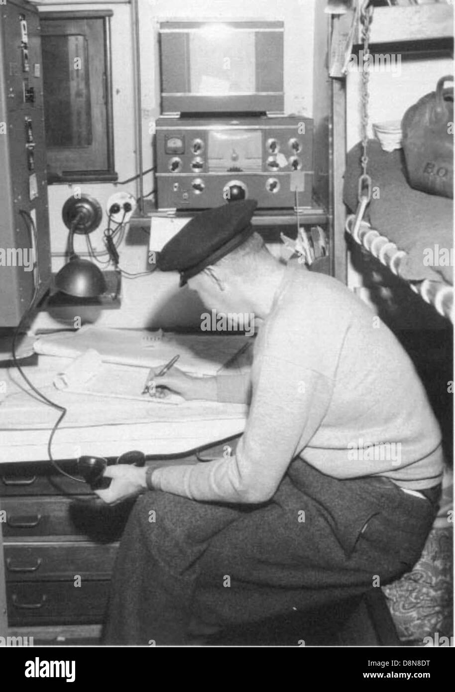 A radiophone operator is pictured using a communication device, with a ...