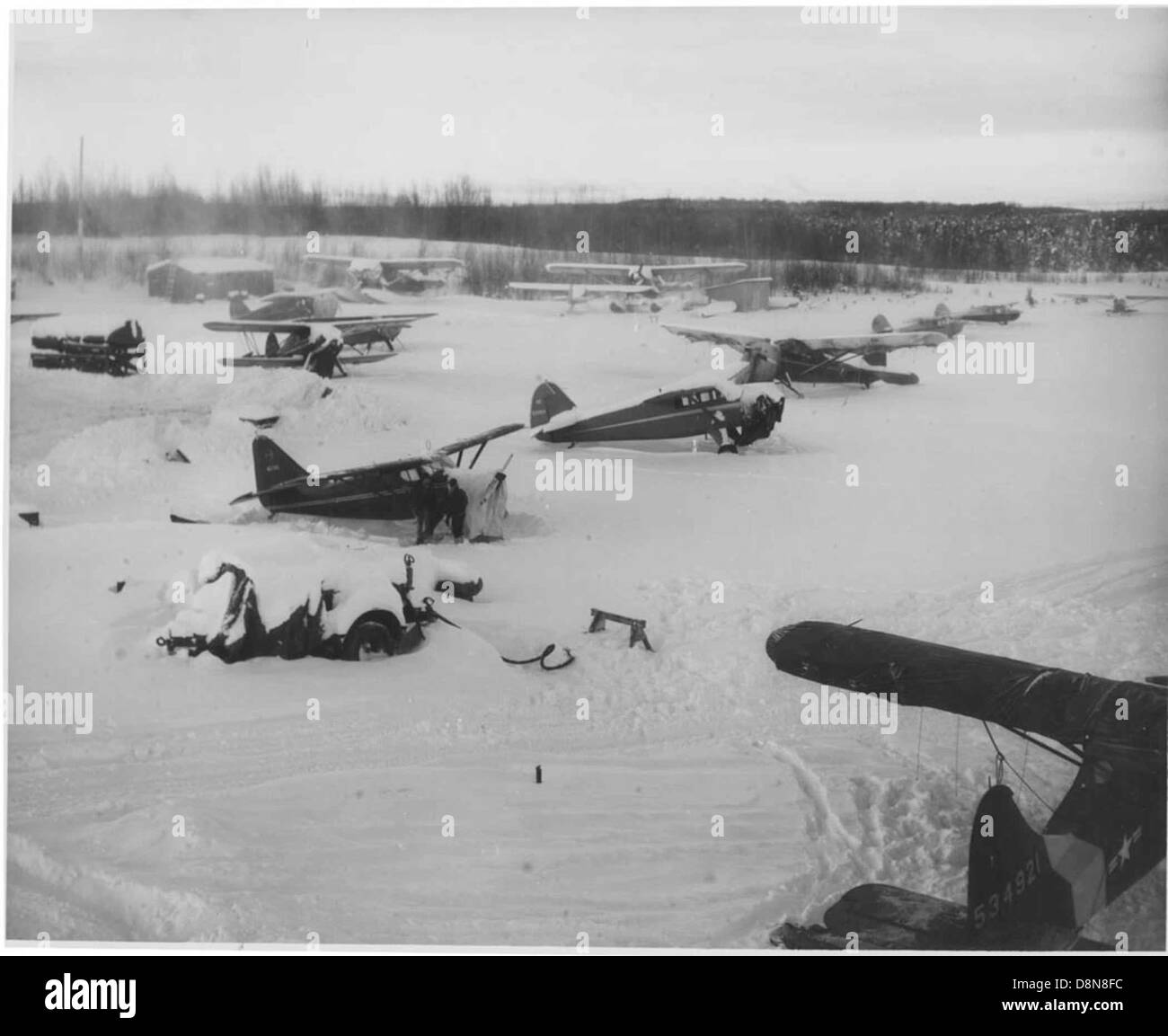 A fleet of planes on the snow-covered ground during winter. The ...
