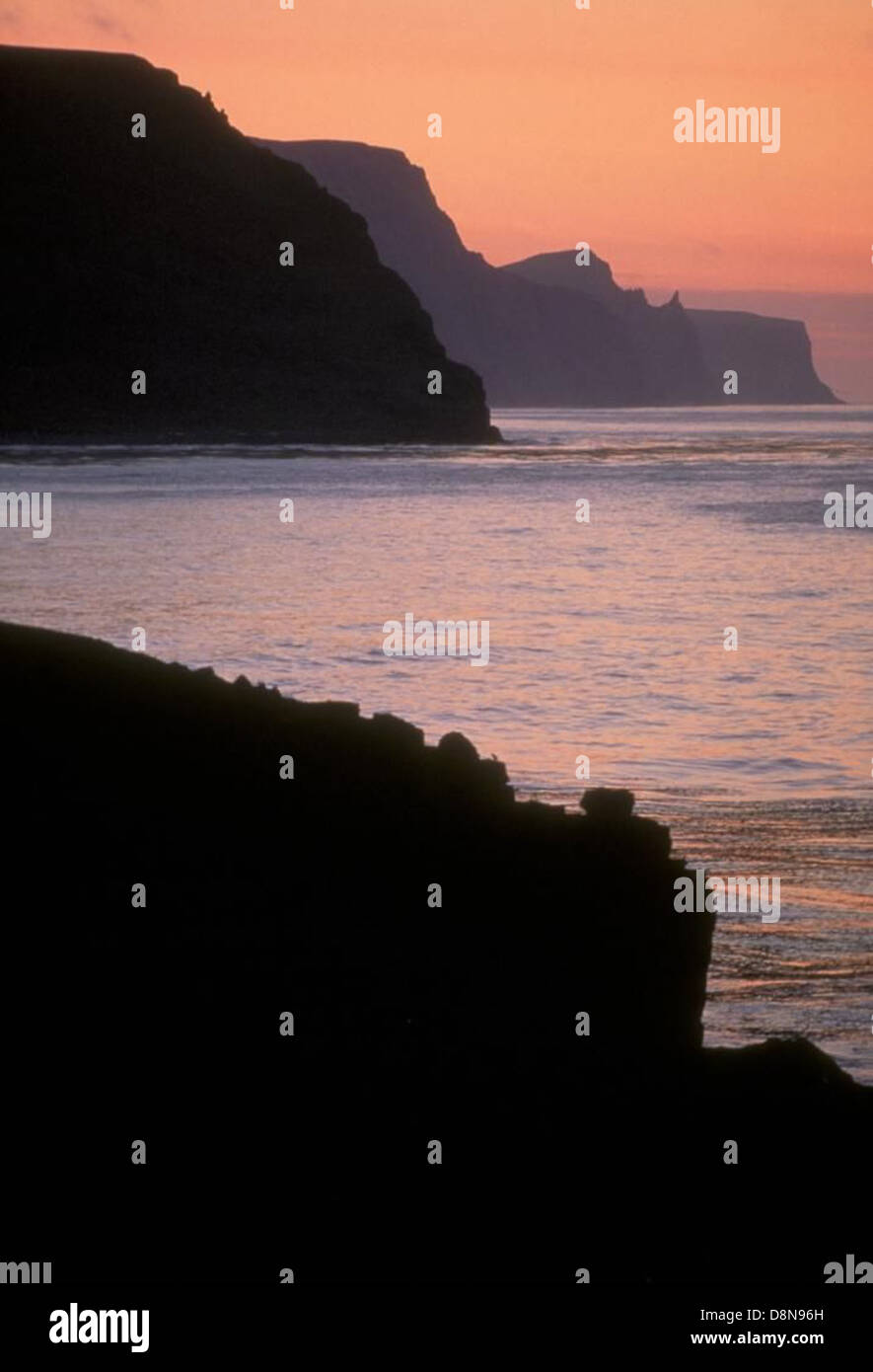 A vibrant sunset over the high bluffs of St. George in the Pribilof ...