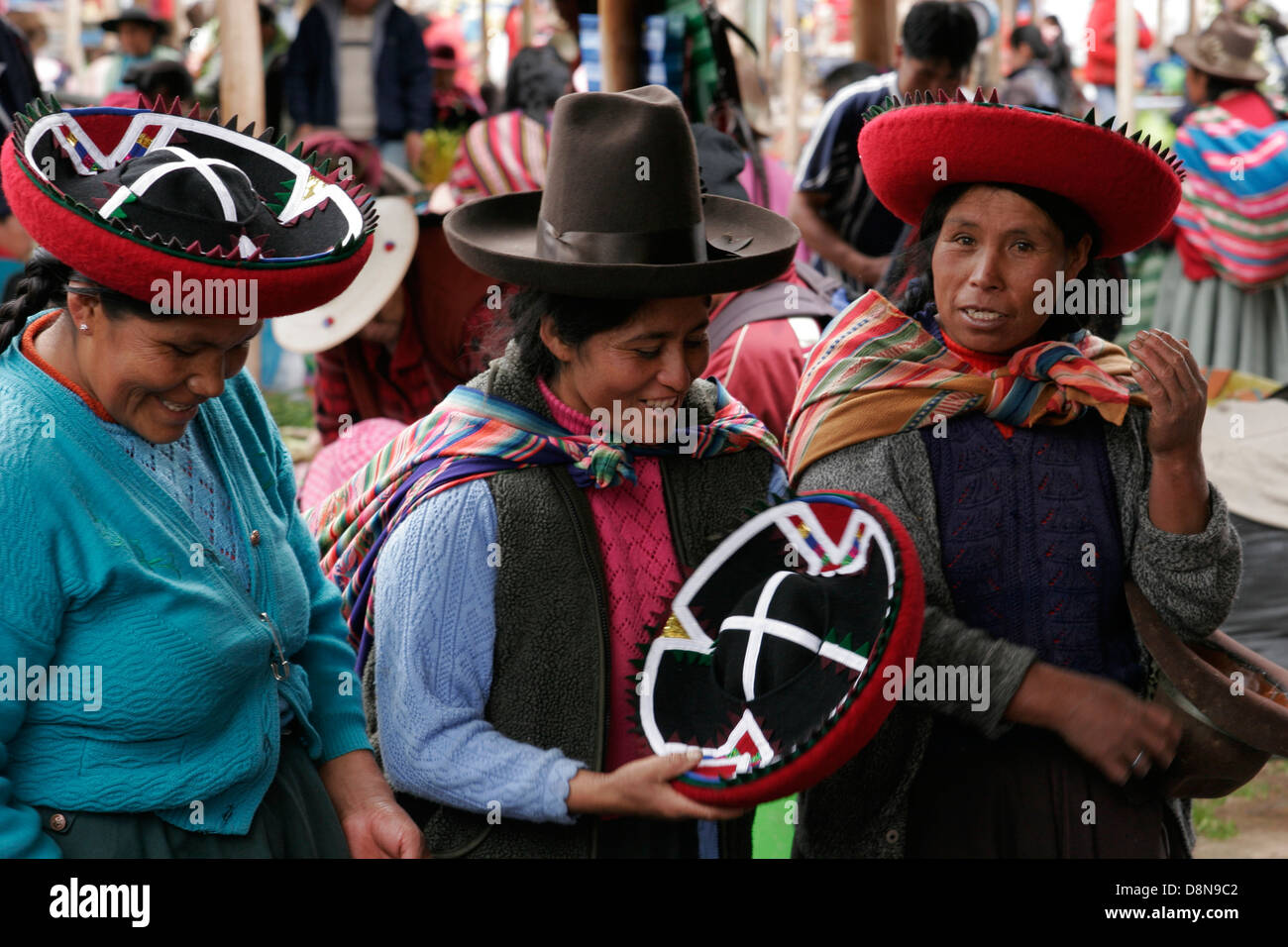 Quechua women choosing and buying traditional round hat on indigenous ...