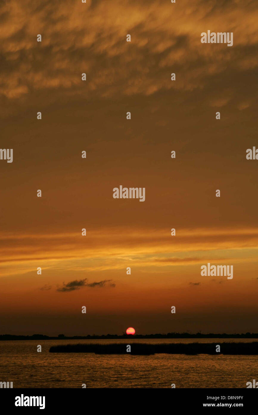 The sky at sunrise is filled with a beautiful display of clouds, tinged ...