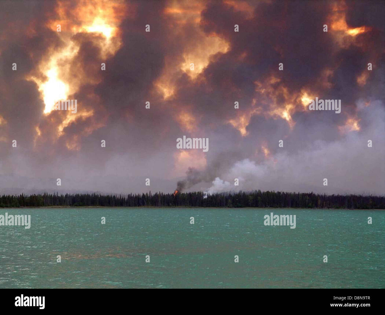 Sunset at day under big smoke rising from fire Stock Photo - Alamy