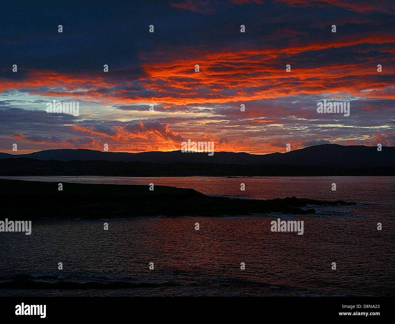 A breathtaking sunset landscape, with the sun dipping below the horizon ...