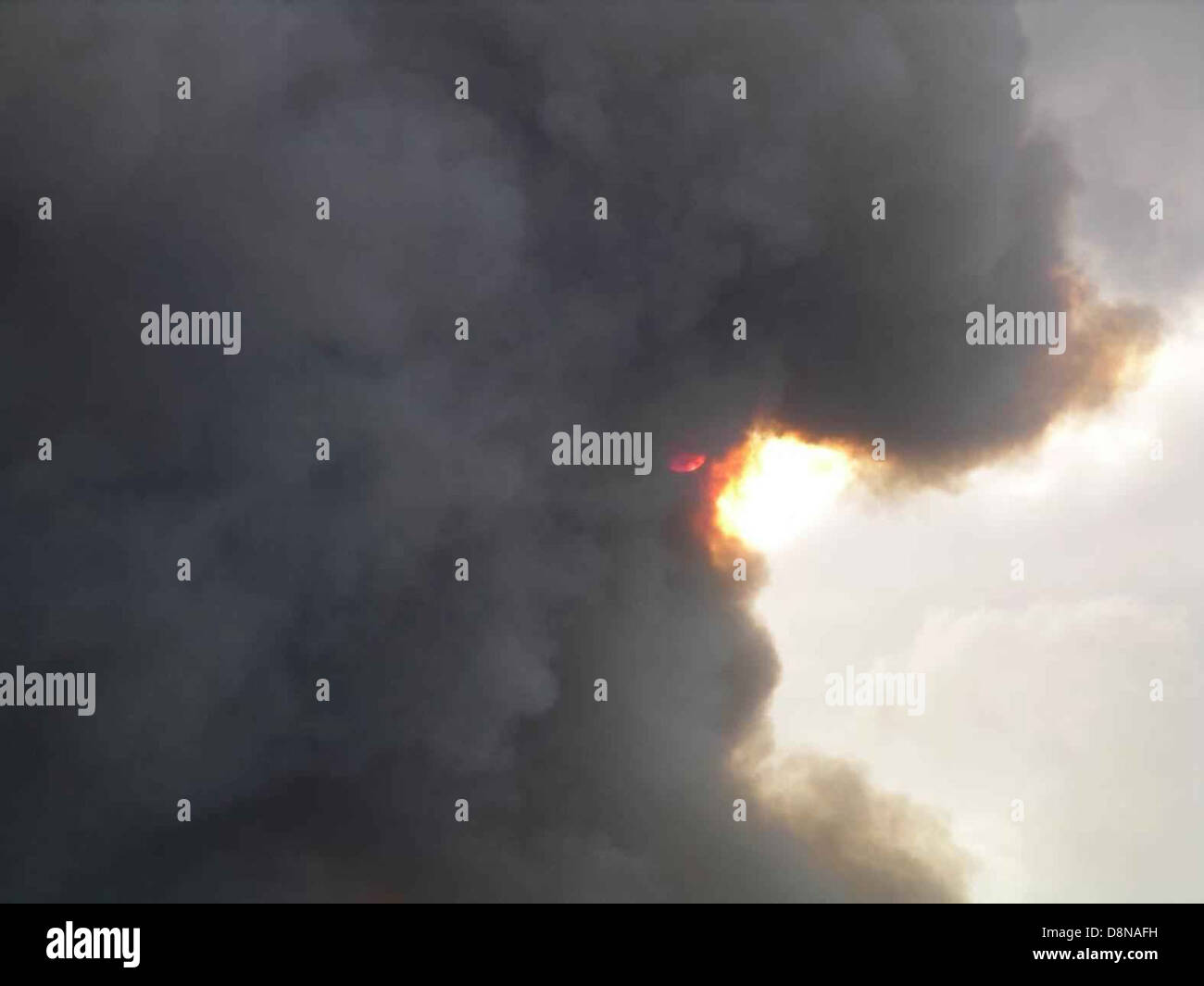 Sun trought smoke on sky Stock Photo - Alamy