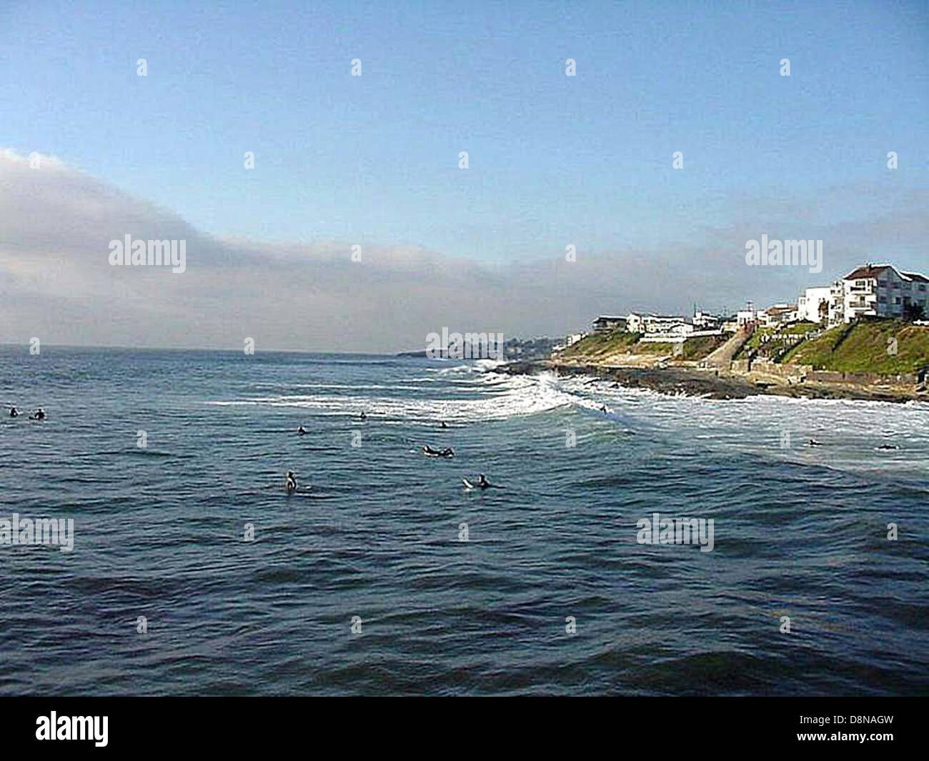 Surfers catch waves at Ocean Beach, showcasing the excitement and skill ...