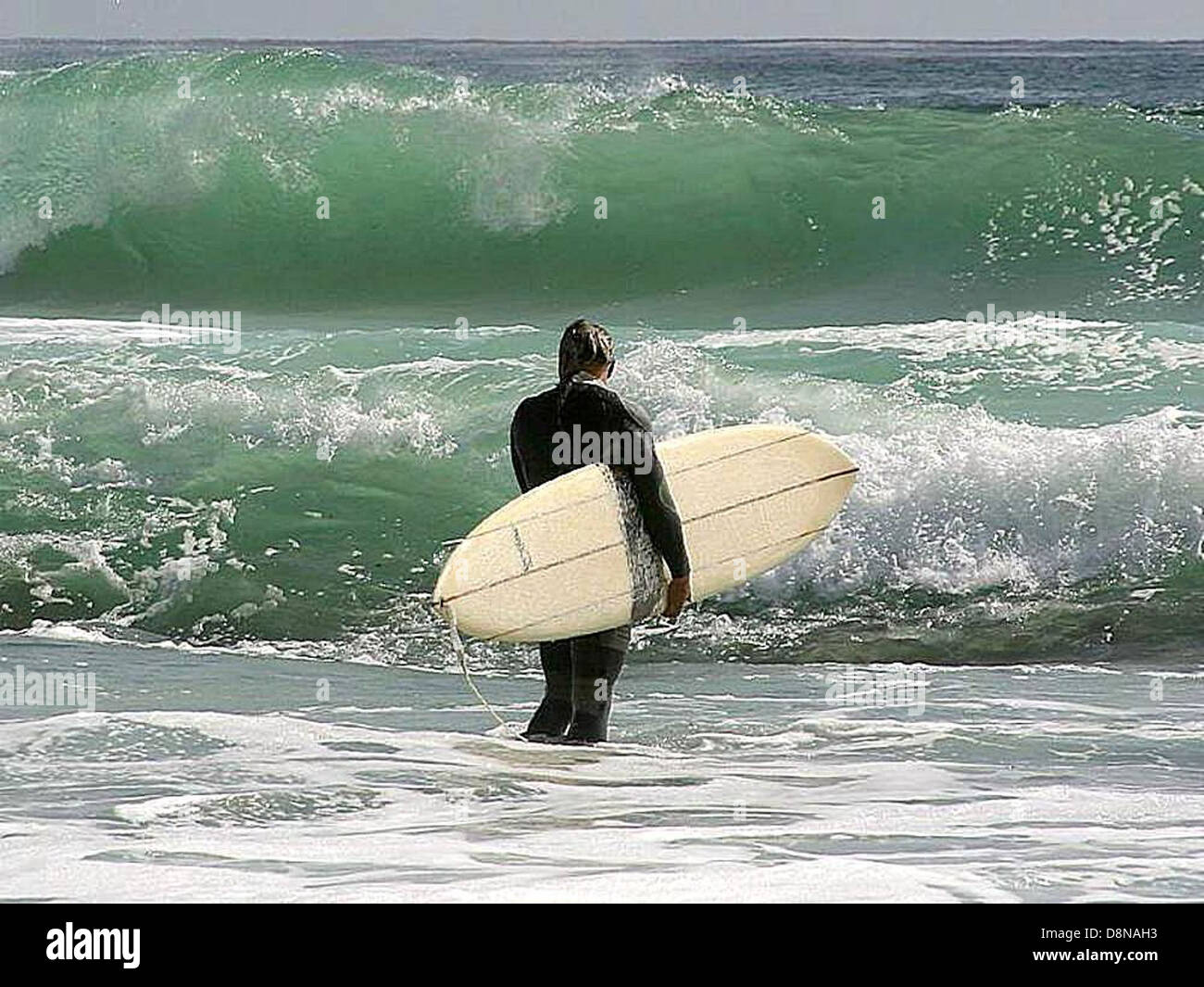This image captures surfers riding waves in the ocean on their ...