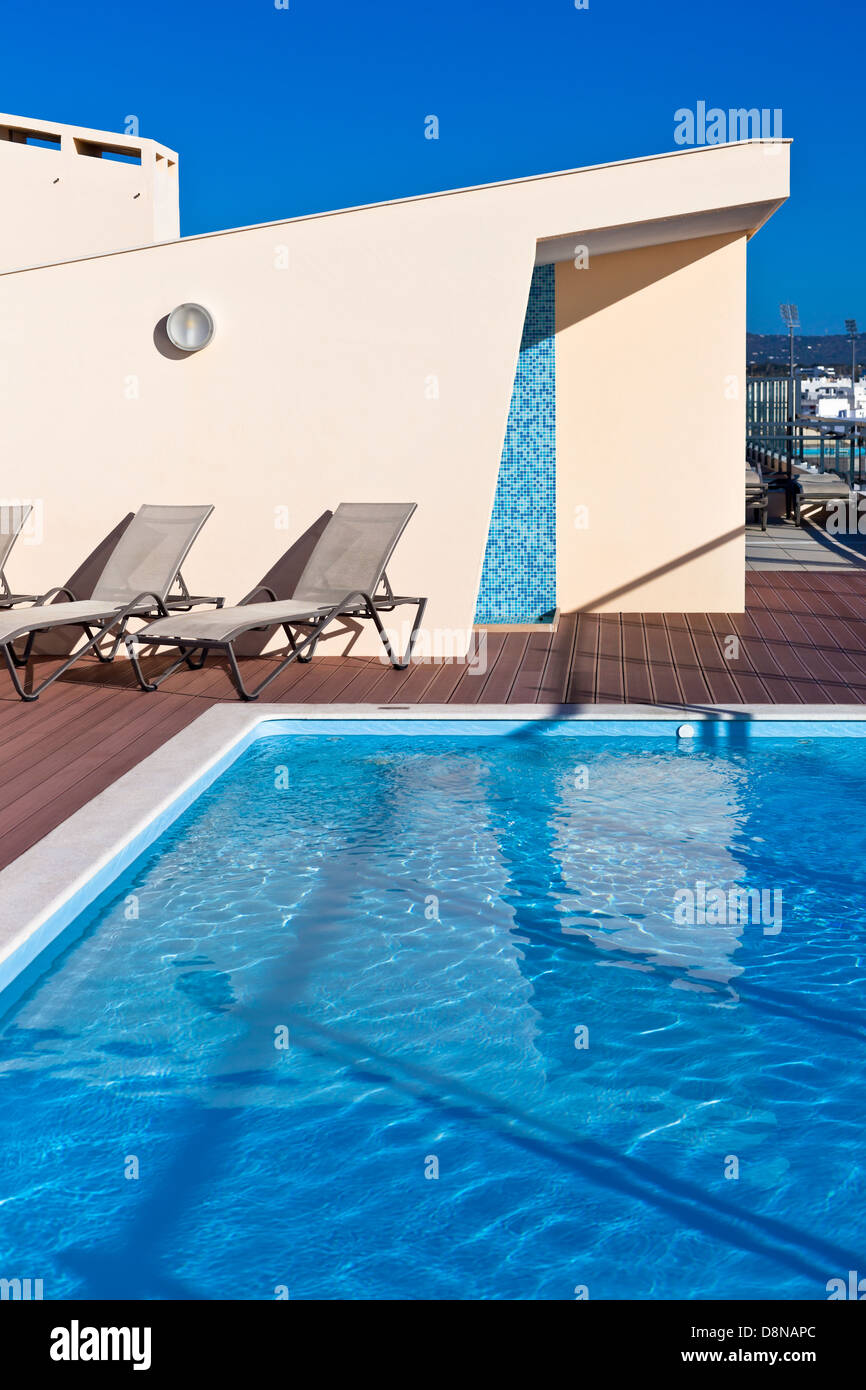 Apartment house with outdoor swimming pool at the roof. Vertical shot ...