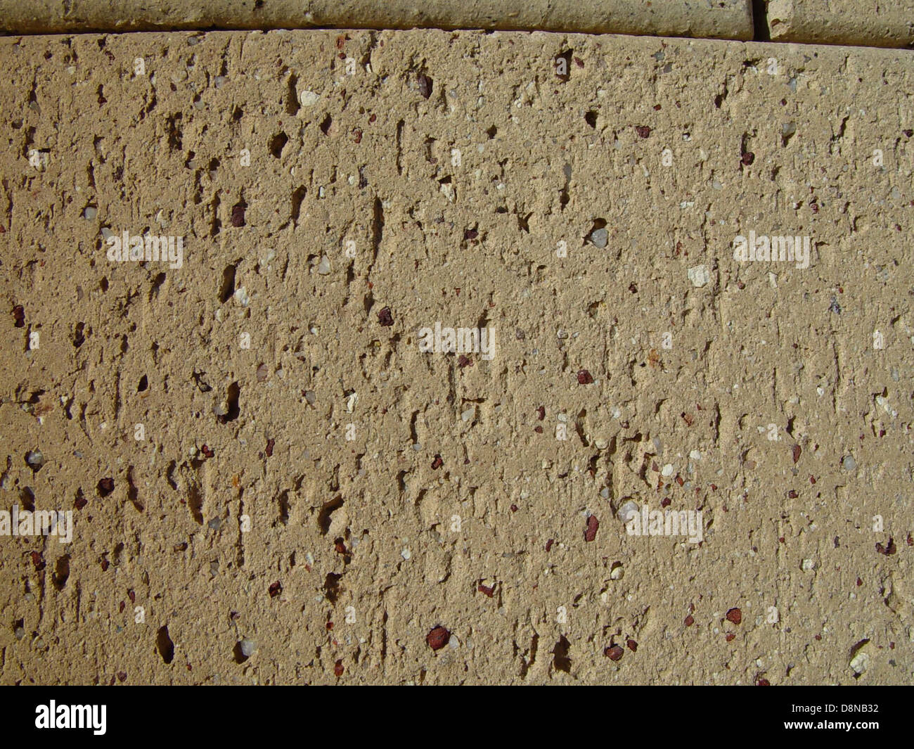A close-up of a tan brick wall texture, showcasing the natural color ...