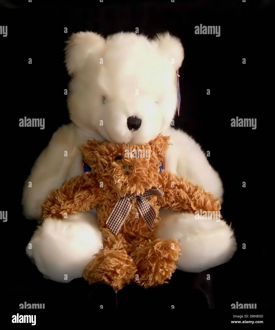 A teddy bear hugs a toy, depicting a tender and comforting scene. Teddy ...