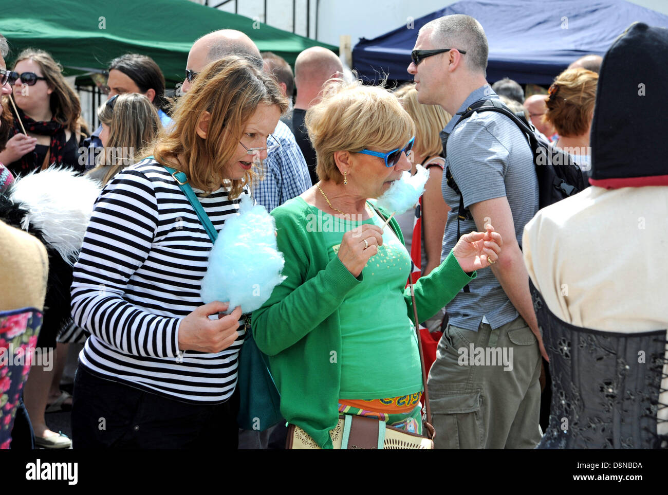 Women eating green candy floss at Kemp Town Carnival Brighton UK Stock ...