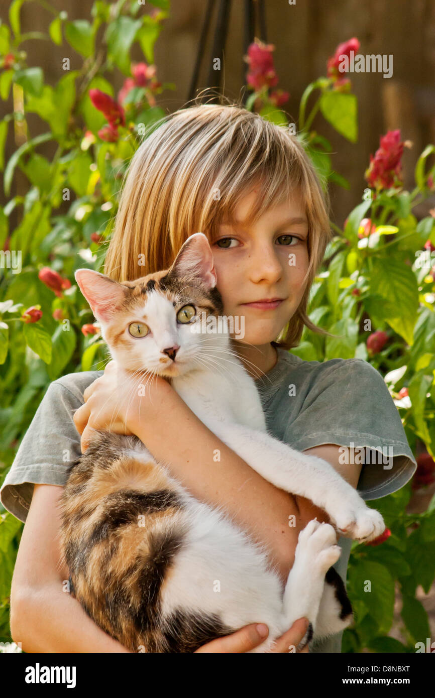 Portrait of boy holding cat , outside.With MR Stock Photo - Alamy
