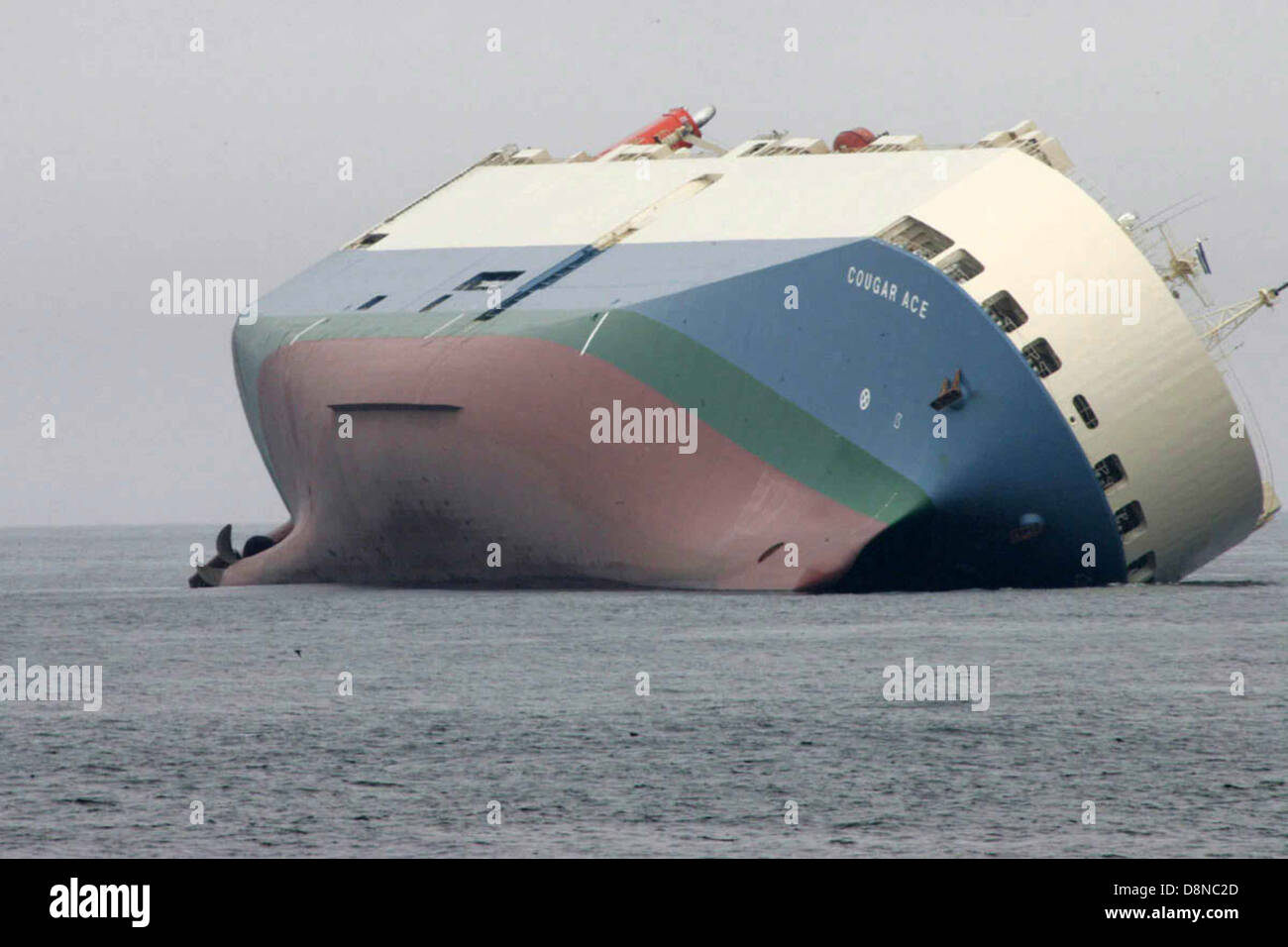 A transportation ship is seen stranded, possibly in shallow waters or ...