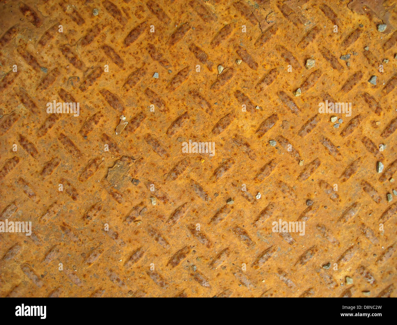 A close-up of rusted tread metal, commonly used in industrial ...