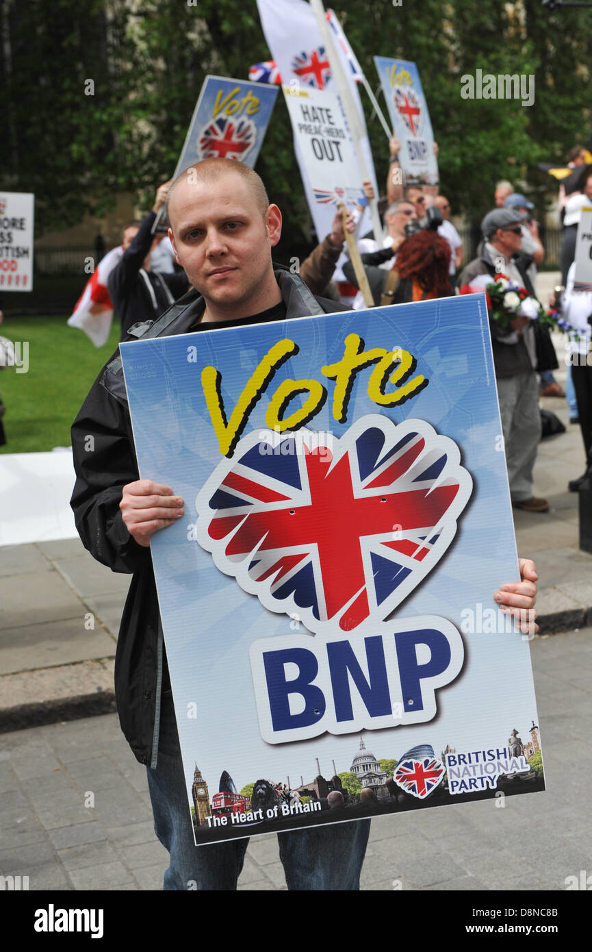 Parliament, London, UK. 1st June 2013. A BNP supporter carries a banner ...