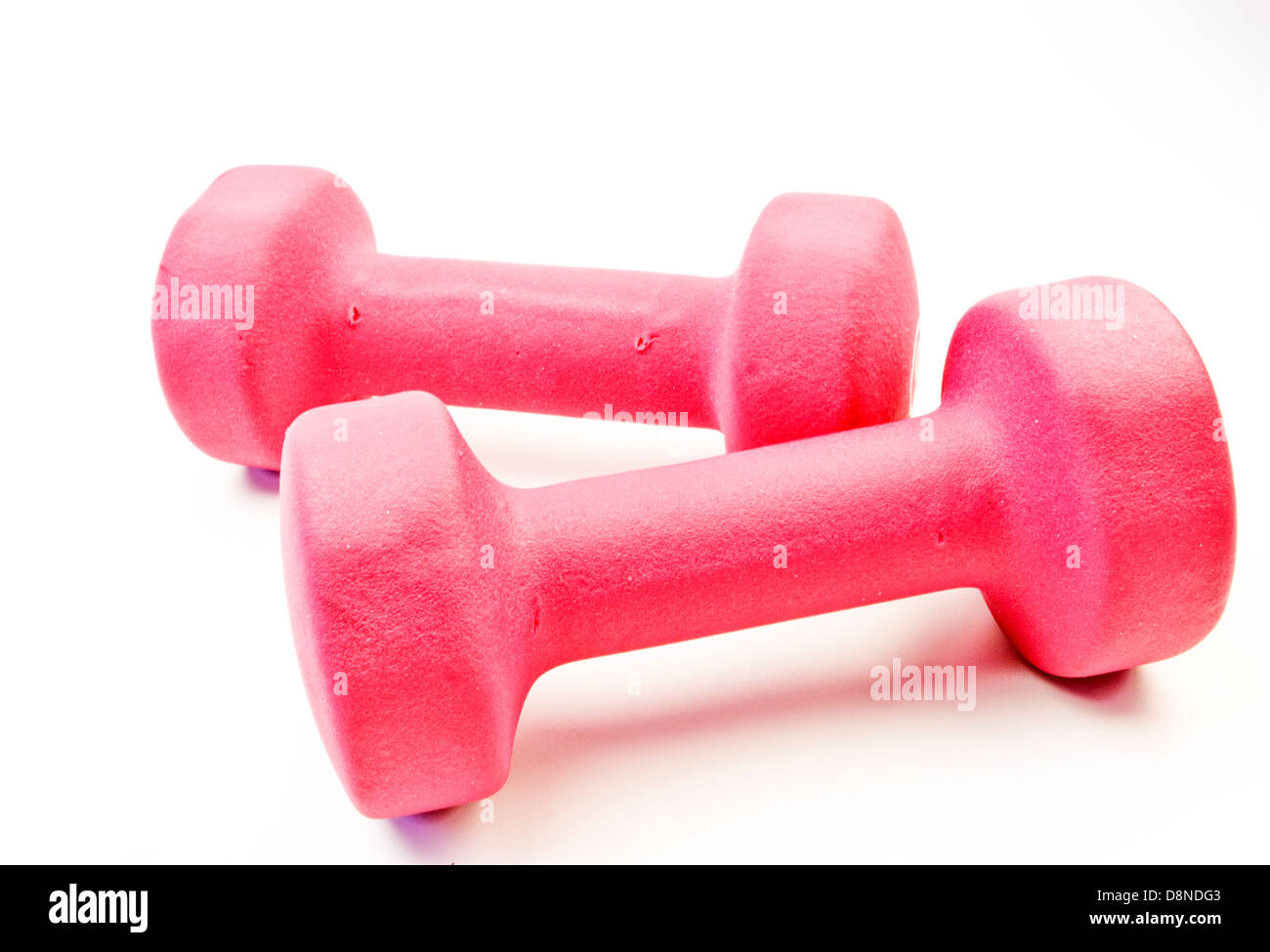 A pair of pink weights is seen against a white background Stock Photo ...