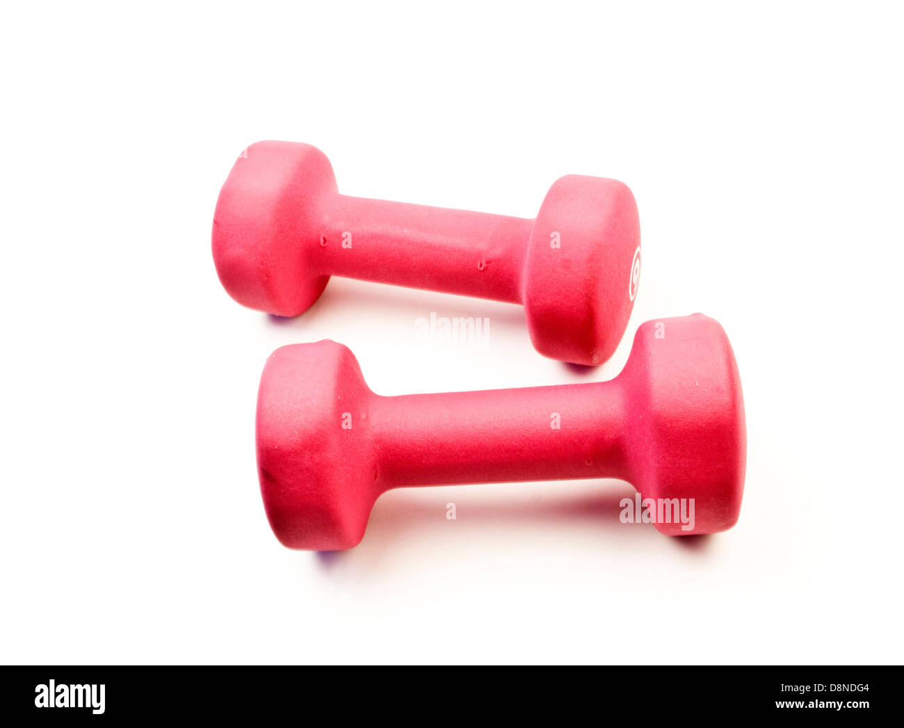 A pair of pink weights is seen against a white background Stock Photo ...