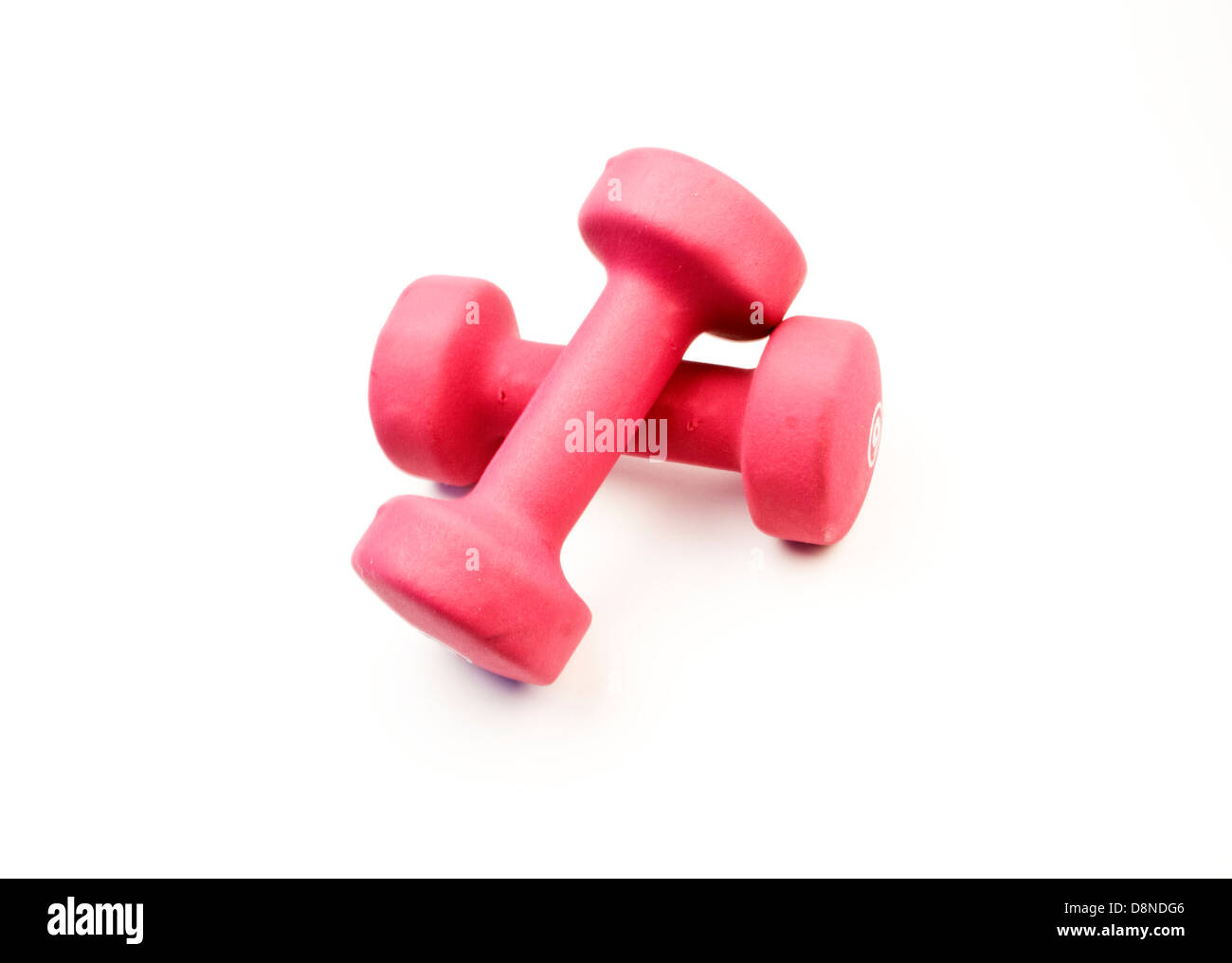 A pair of pink weights is seen against a white background Stock Photo ...