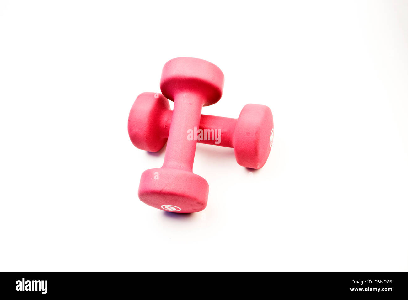 A pair of pink weights is seen against a white background Stock Photo ...