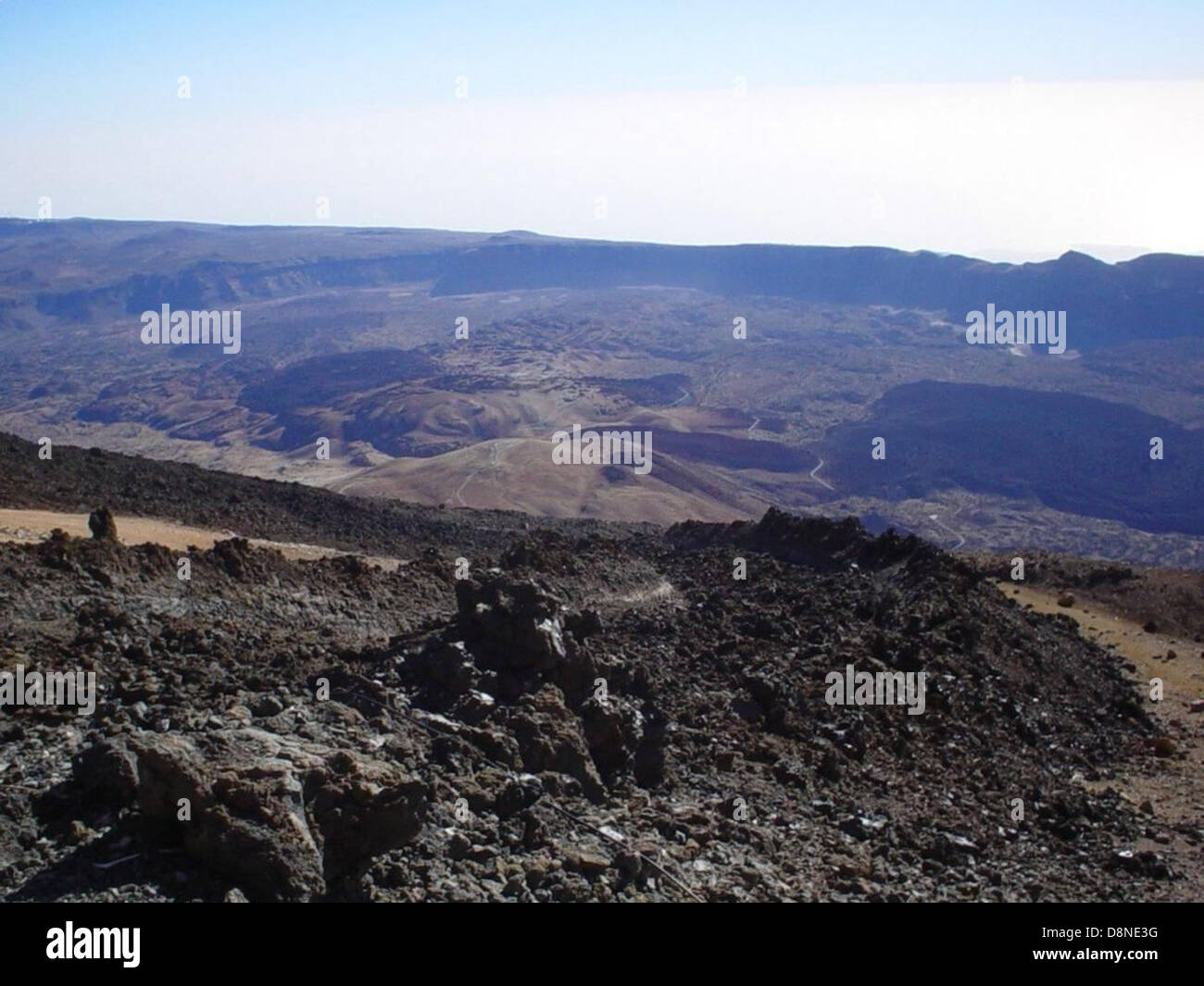 A vast volcanic landscape with rugged terrain, hardened lava fields ...