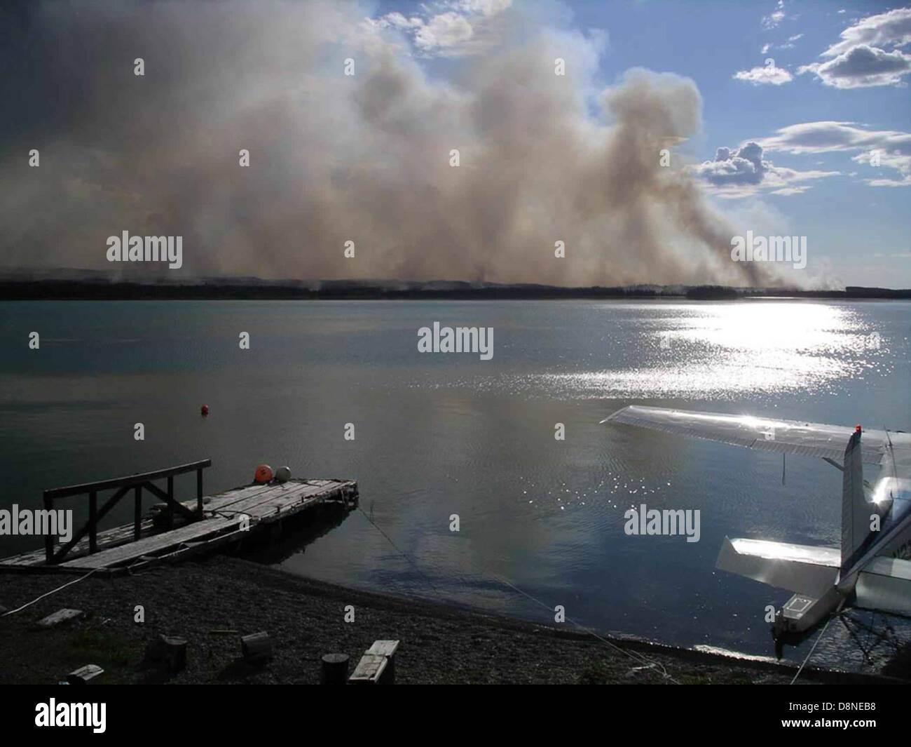 Watching burning fire from distance Stock Photo - Alamy