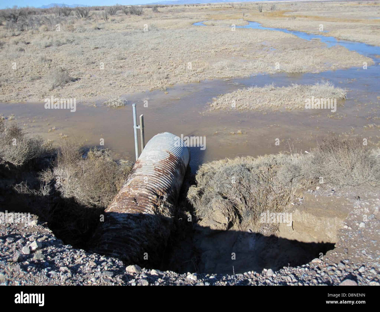 Water flows out of a runoff pipe, often the result of rainfall or water ...