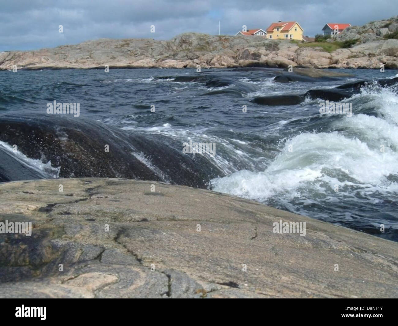 Water waves over rocks Stock Photo - Alamy
