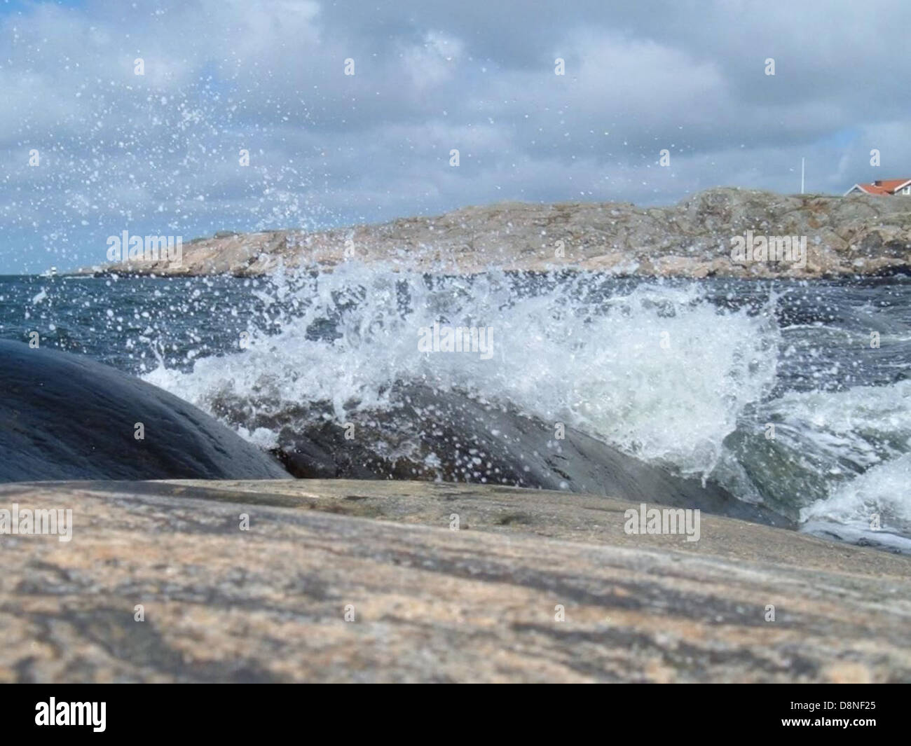 Water wave over rock Stock Photo - Alamy