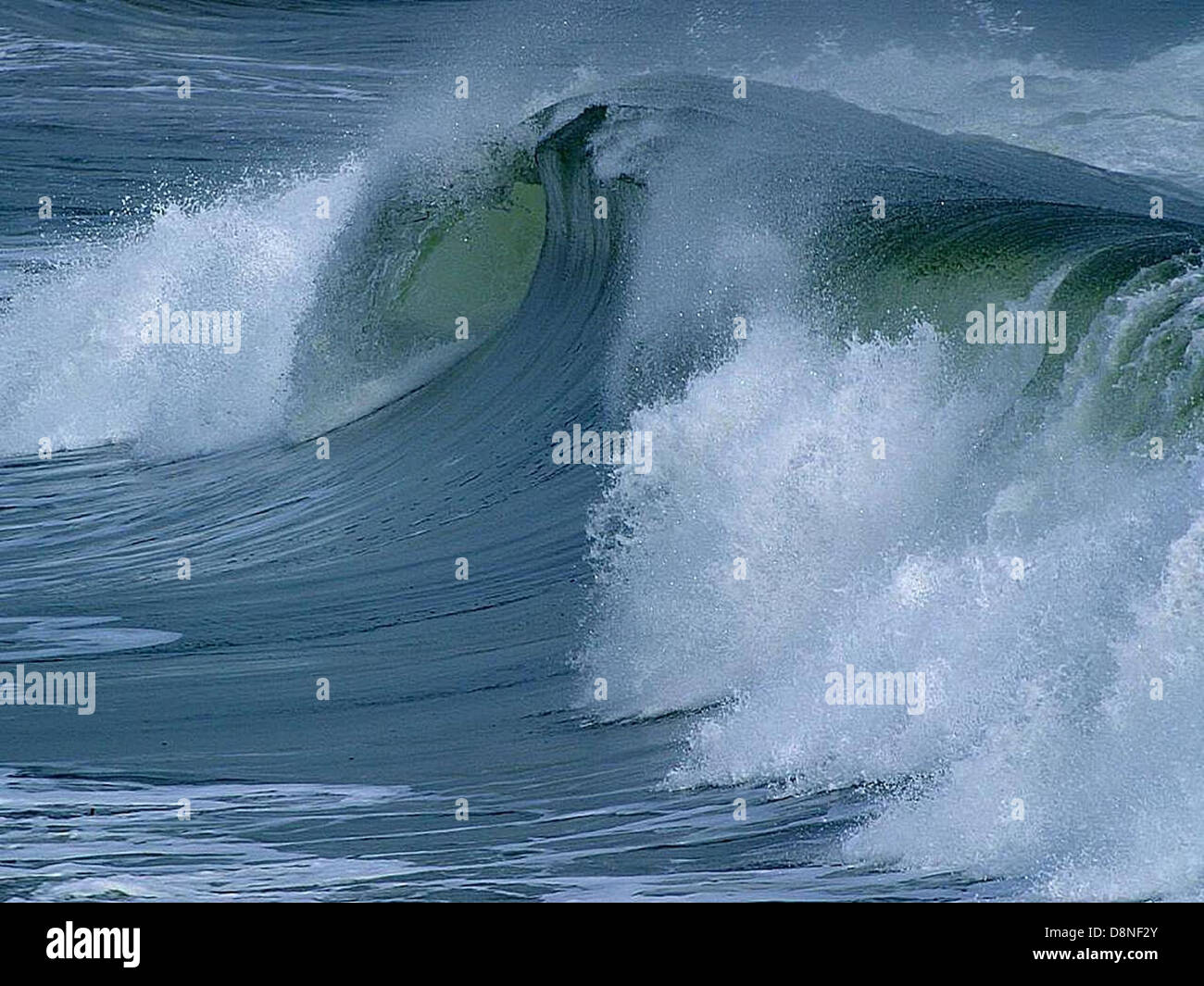 This photo captures a surfer riding the waves at an ocean beach. The ...
