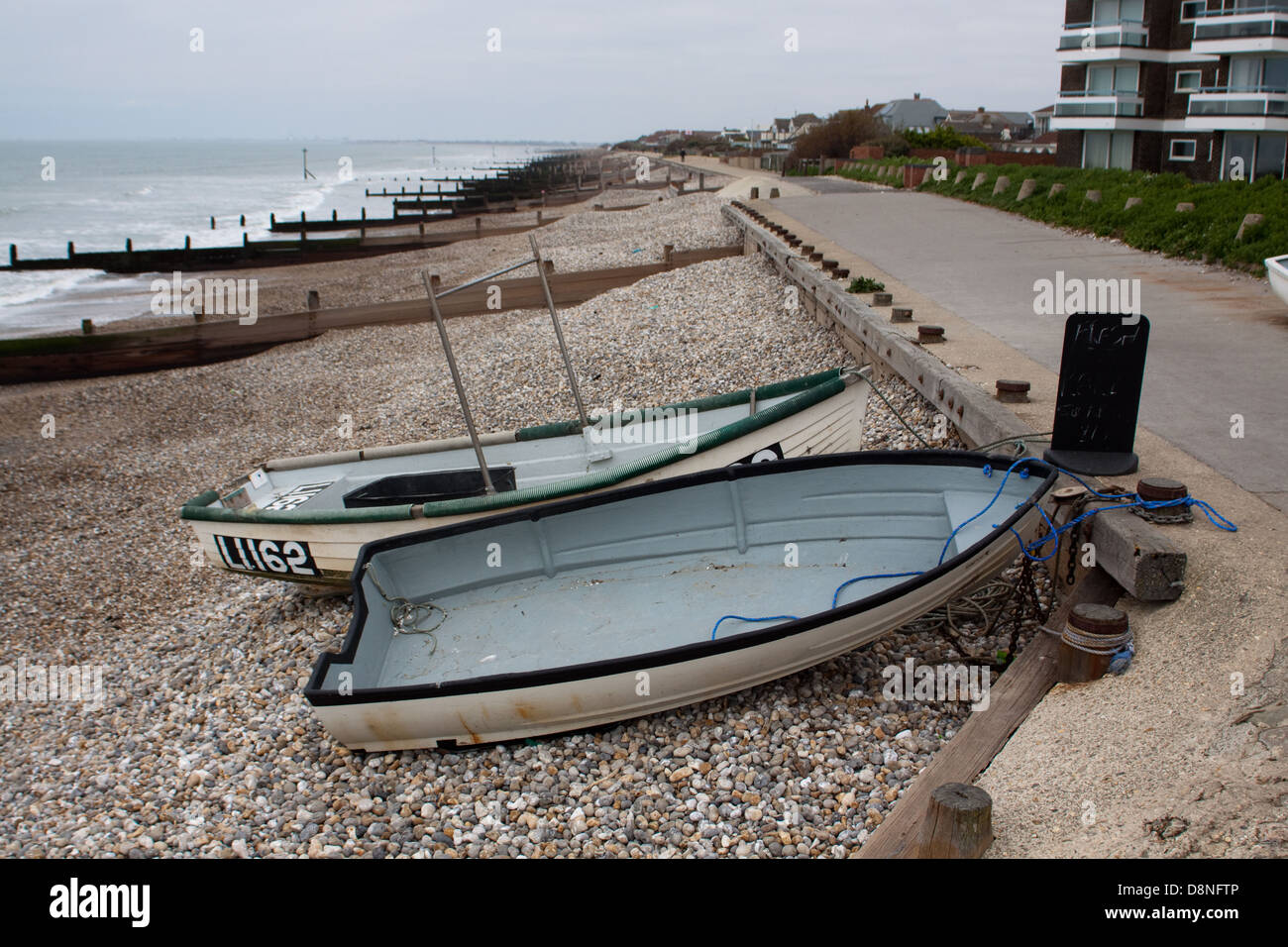 A pair of boats on the pebble beach at East Wittering, West Sussex ...