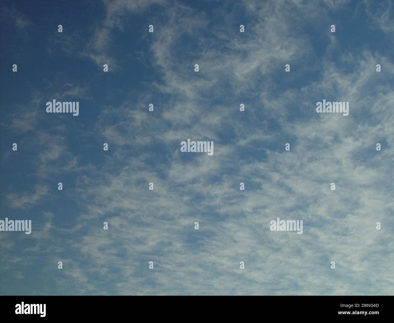 Soft, thin clouds float across the sky, creating a delicate and airy ...