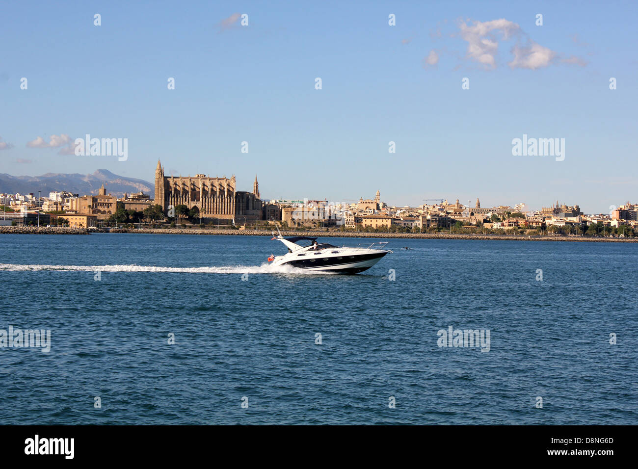 Fairline motor yacht departing port past historic Palma Gothic ...