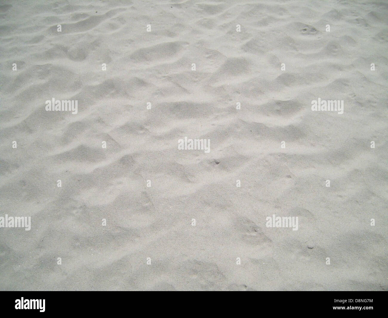 A pristine white sand beach stretches along the coastline, with soft ...