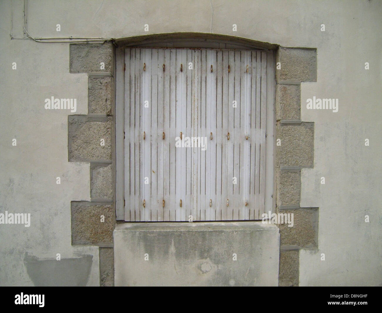 A traditional wooden window shutter, showcasing its function and design ...