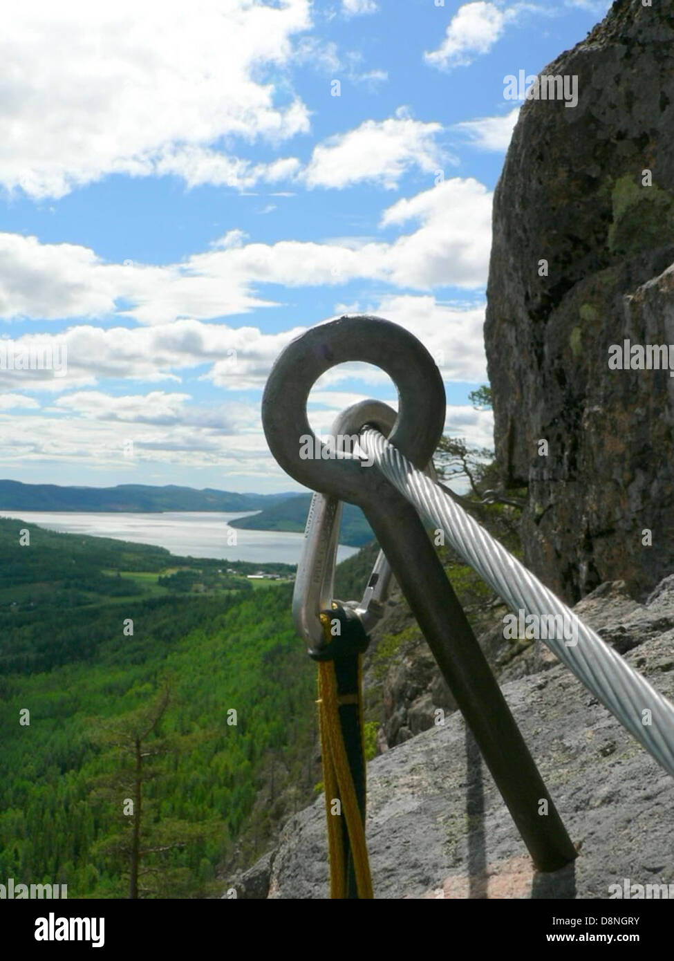A person climbing a mountain using wire ropes for safety. The climber ...