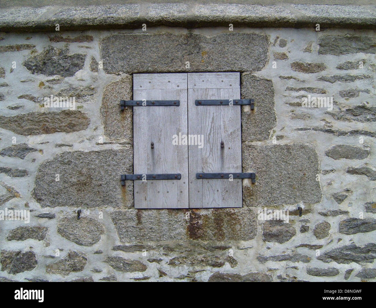 A pair of wooden shutters on a window, commonly used for both practical ...