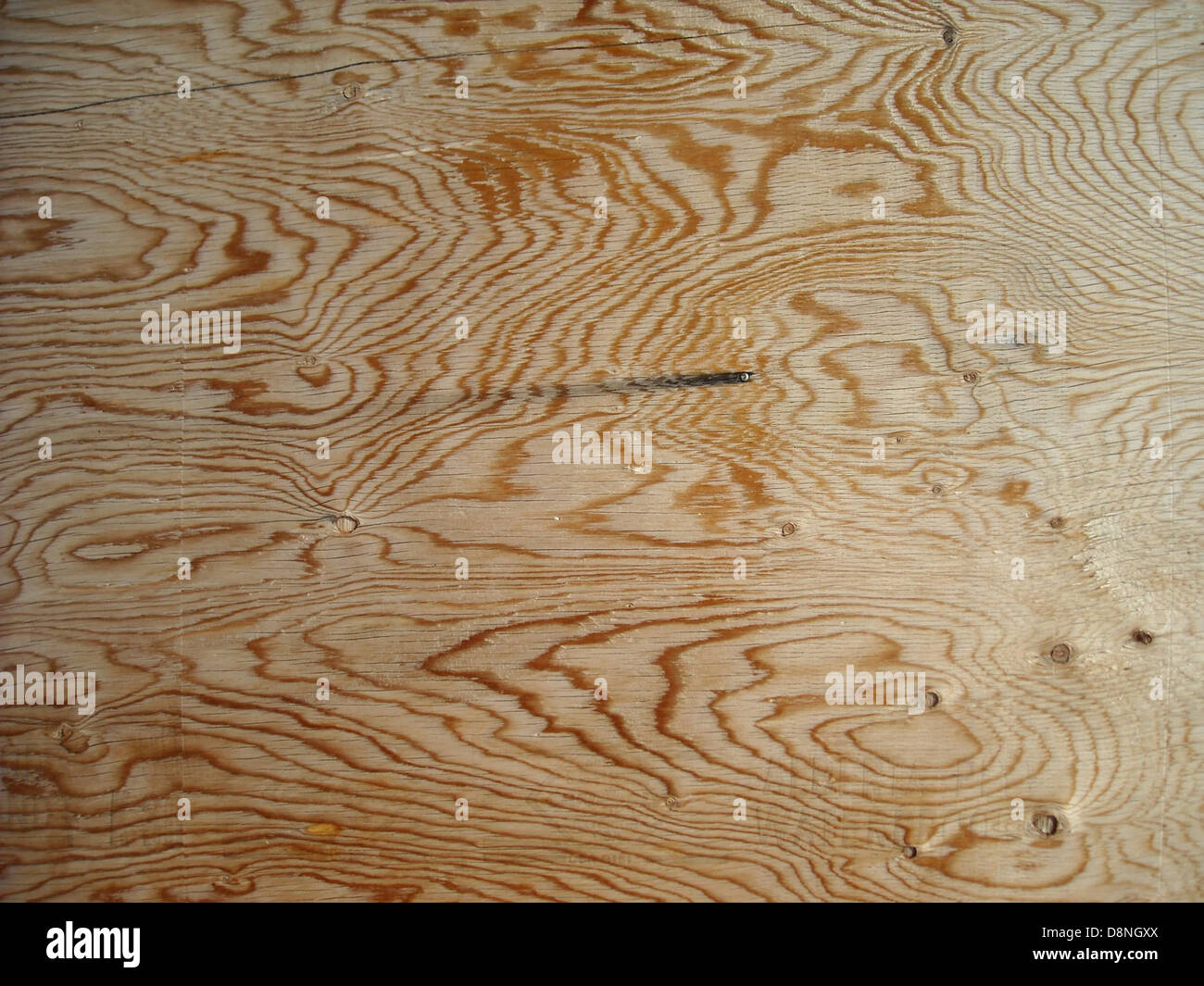 A light-colored wood surface, offering a natural and warm background ...