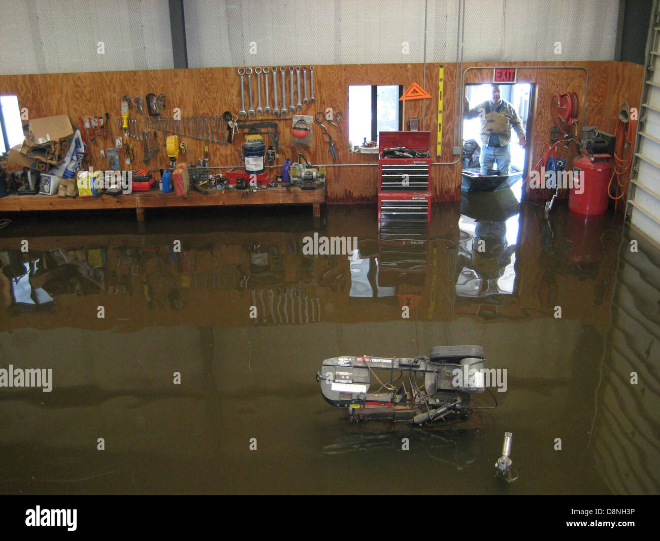 A flood in a workshop, with water covering the floor and affecting the ...