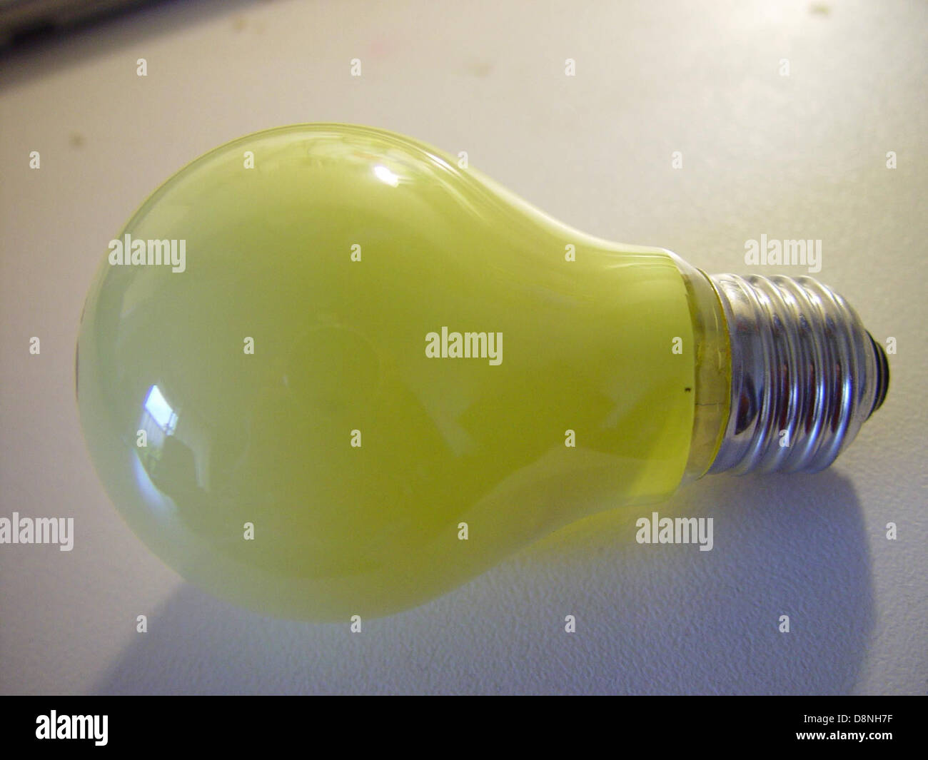 A yellow insect repellant light globe with a screw fitting, commonly ...