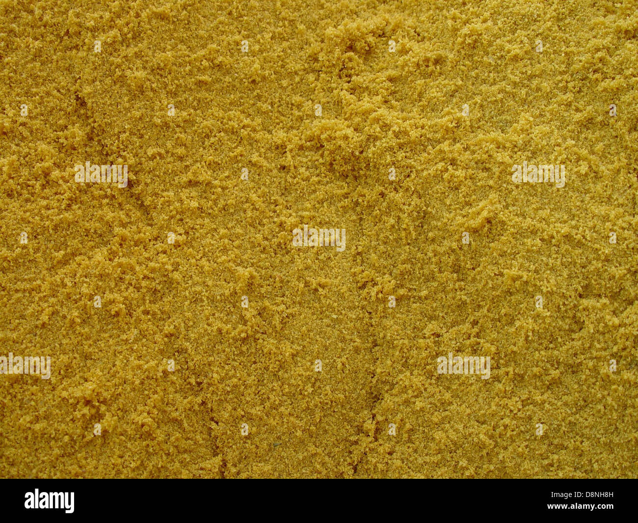 A detailed image of yellow sand, showing the fine, grainy texture that ...