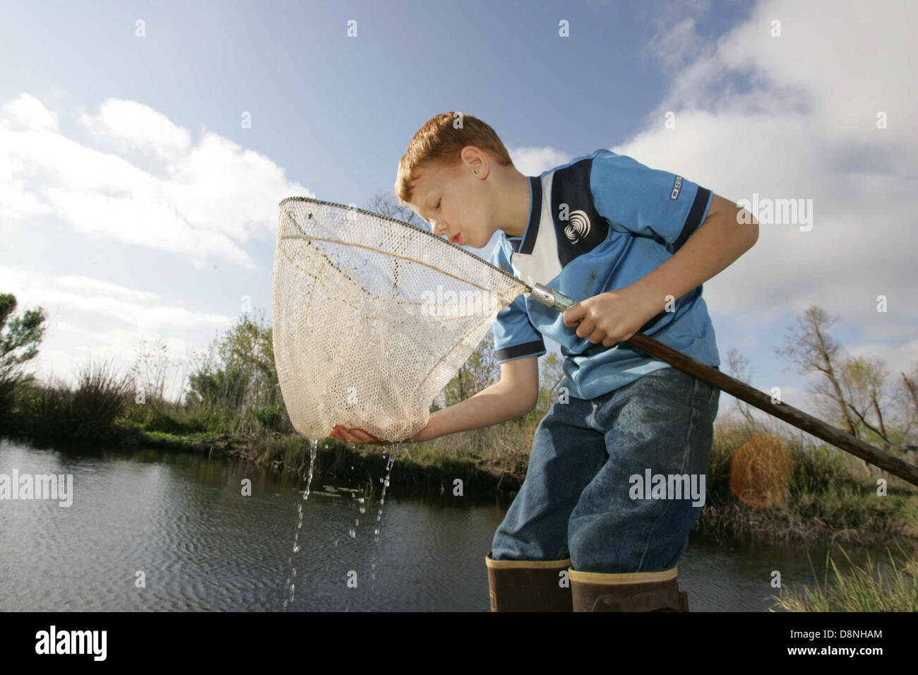 Young boy catches fish close up Stock Photo - Alamy