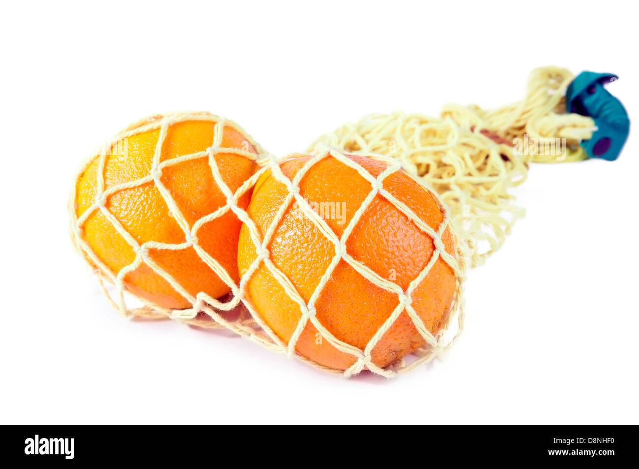 Yellow string bag with oranges on the white background Stock Photo - Alamy