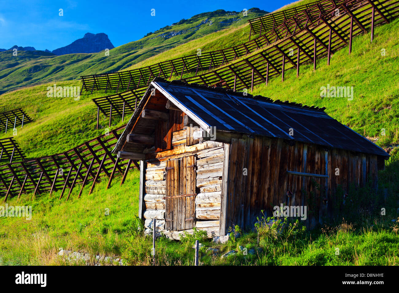 Small barn on Alps mountains background Stock Photo - Alamy